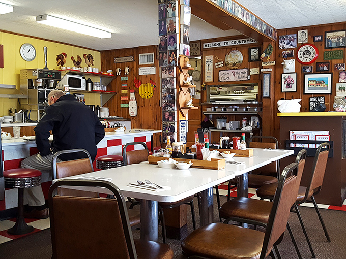 Inside, time stands deliciously still. Wood paneling, chicken collectibles, and decades of memories line walls that have witnessed countless coffee refills.