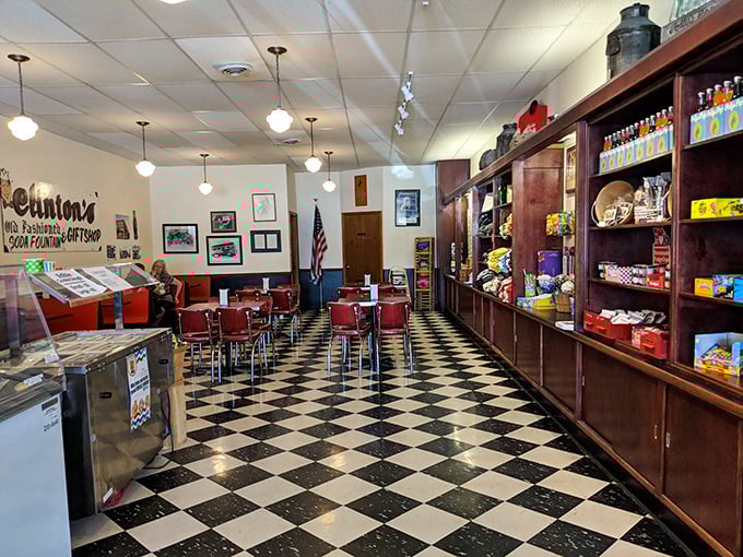 Inside, the checkerboard floor and red vinyl chairs aren't retro by design—they're authentic relics from an era when conversation flowed as freely as the ice cream.
