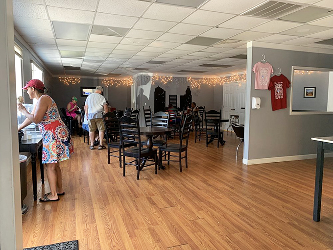 String lights create a warm glow in this cozy dining area, where wooden floors and black chairs invite you to sit and savor every spoonful.