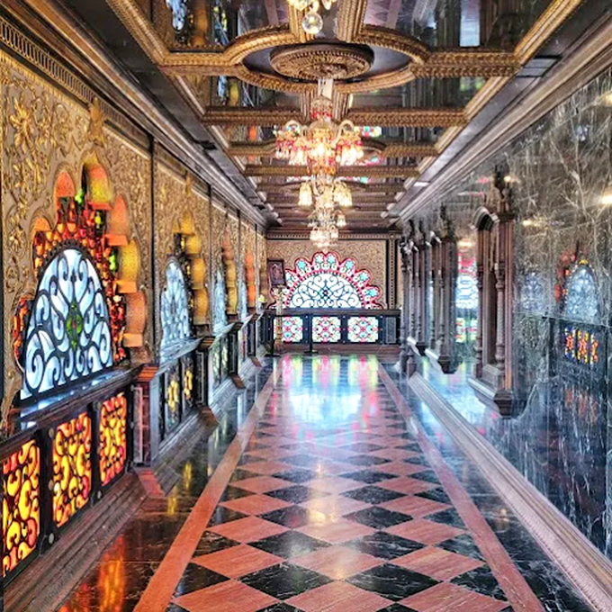 A hallway where every surface competes for the "most ornate" award. The chandeliers alone have more sparkle than a 1970s disco ball convention.