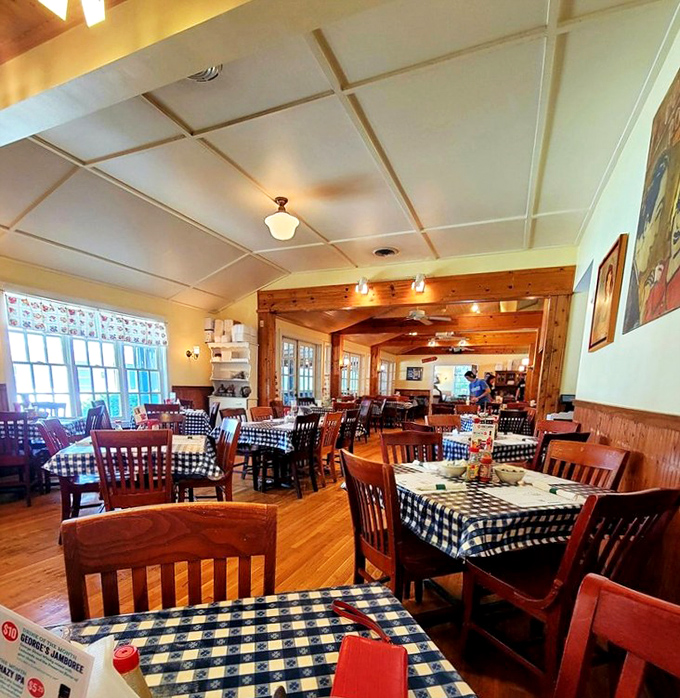 Classic checkered tablecloths and warm wood tones create the perfect stage for breakfast theater, where Southern cuisine takes the spotlight daily.