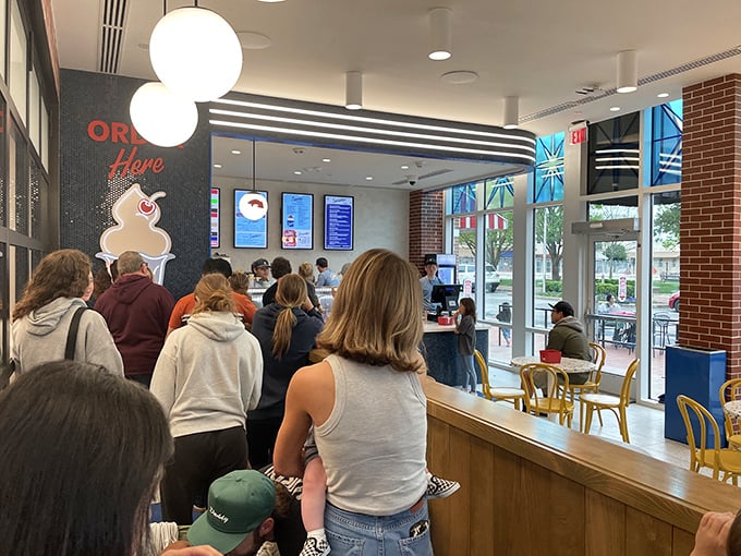 The line forms for a reason! Inside, patrons wait patiently for their frozen reward, knowing some pleasures are worth every minute spent.