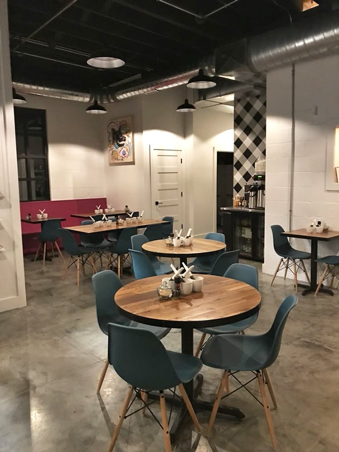 Mid-century modern meets morning magic in this thoughtfully designed space where blue chairs invite you to settle in for something extraordinary.