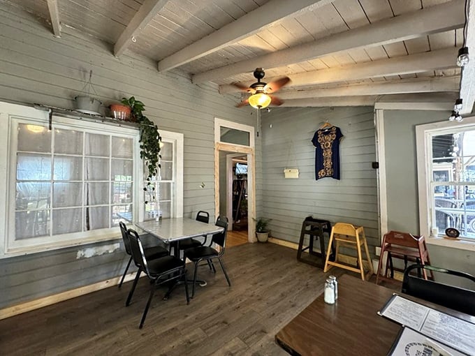 Simple wooden tables, exposed beams, and pale blue walls create the perfect backdrop for the flavor explosion about to hit your plate.