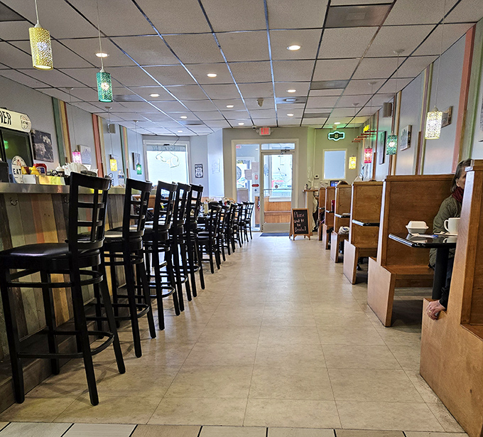 Classic diner geometry: wooden booths for families, counter seating for the regulars, and colorful pendant lights that cast a glow worthy of Edward Hopper's "Nighthawks."