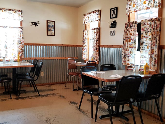 Corrugated metal meets nostalgic Route 66 curtains in this no-frills dining room. The decor isn't trying to impress you&mdash;it's too busy being authentically itself.