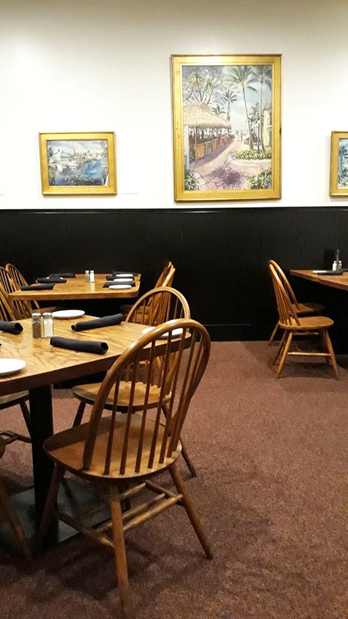 Classic Windsor chairs and Florida artwork create that rare dining atmosphere where conversations flow as easily as the au jus. No Instagram filters required.