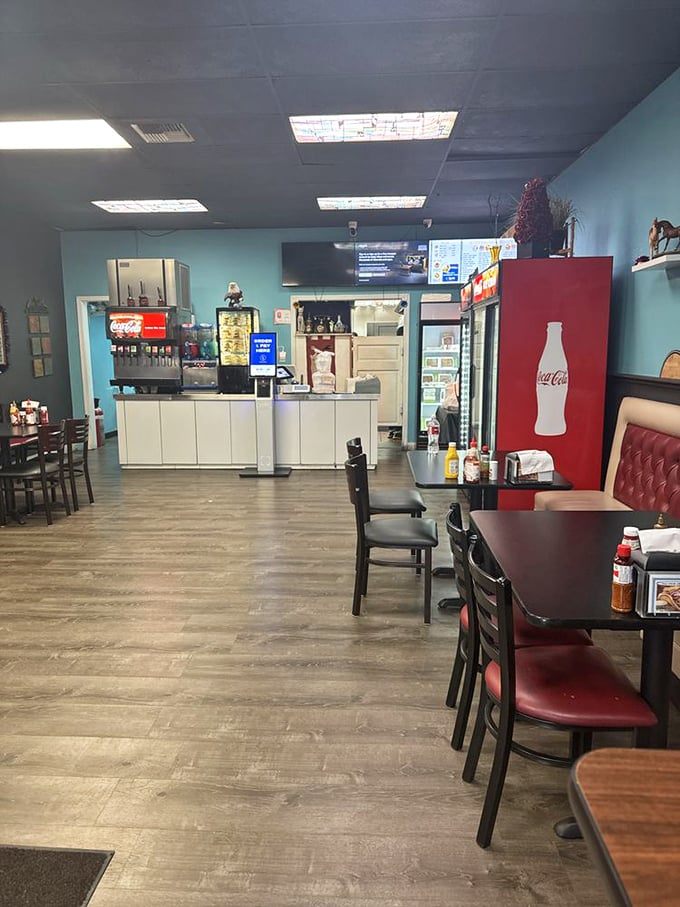 Simple blue walls, practical seating, and a Coca-Cola fridge that stands like a red sentinel. This place prioritizes what's on your plate, not your Instagram.