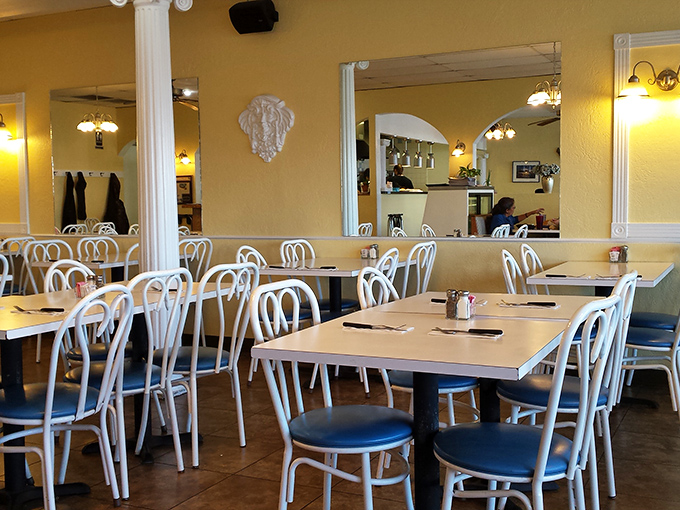 Sunshine-yellow walls and classic white chairs create that perfect "neighborhood taverna" vibe. No Instagram filters needed—just honest ambiance and the promise of good eating.