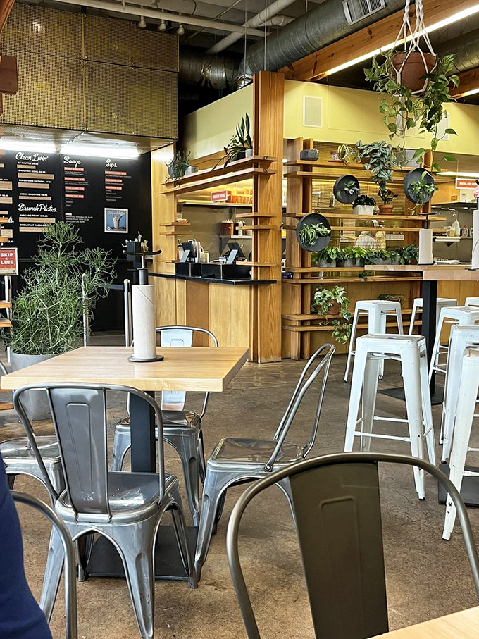 Industrial meets cozy with hanging plants softening metal and wood. The stage is set for waffle magic to happen.