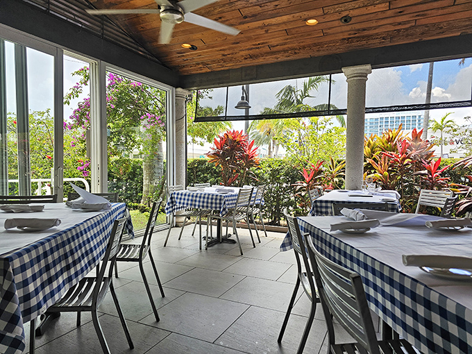 Wooden ceilings, blue checkered tablecloths, and tropical plants create that rare "vacation in your hometown" feeling. Somewhere Zorba is nodding in approval.
