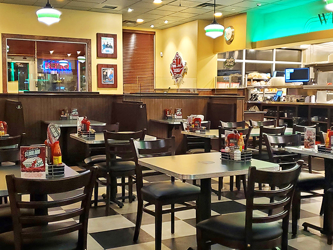 Classic diner ambiance meets modern comfort in this checkerboard-floored haven. The pendant lights cast that perfect "you're about to eat something amazing" glow.