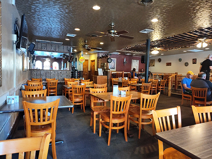 Wooden chairs, ambient lighting, and thoughtful decor create that perfect "come as you are, stay as long as you'd like" atmosphere that defines great neighborhood restaurants.