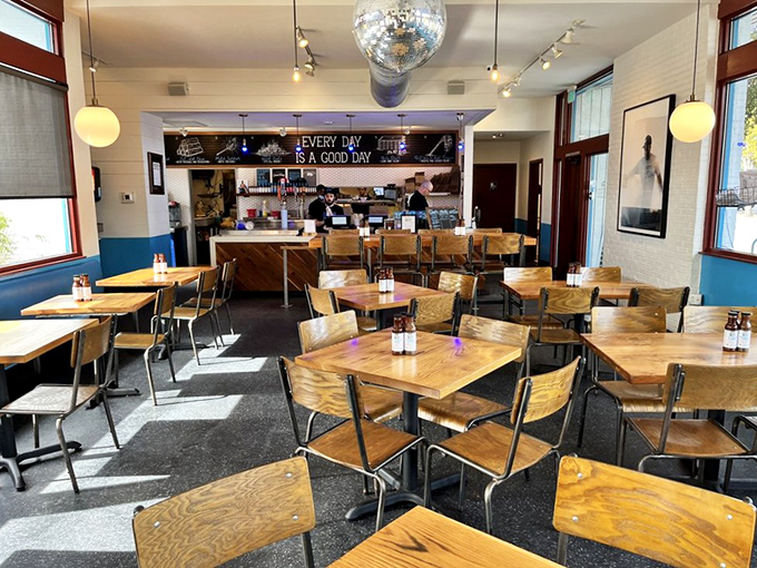 Every day IS a good day when your dining room sports a disco ball. Simple wooden tables let the food be the star.