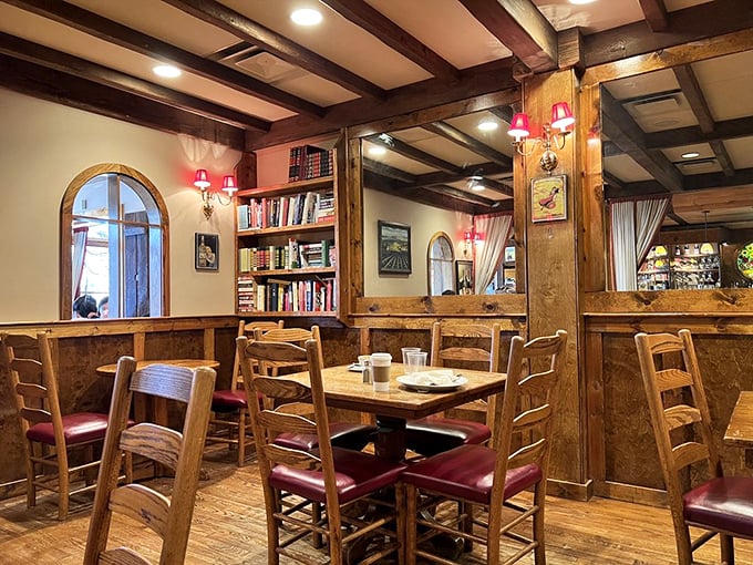 Wooden beams, warm lighting, and bookshelves create that rare atmosphere where you feel sophisticated enough to discuss Sartre while secretly Googling who he was.