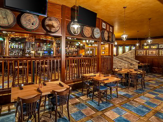 Wooden barrels line the walls above a gleaming bar, creating that authentic Irish pub atmosphere where even strangers feel like old friends.