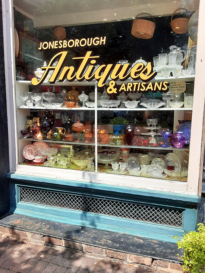 A kaleidoscope of vintage treasures beckons from behind glass - each colorful piece of glassware holds stories waiting to be discovered.