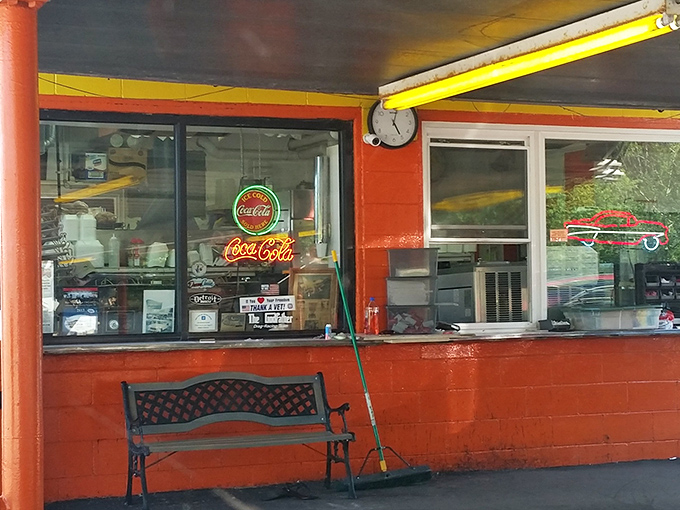 The ordering window, framed by that unmistakable orange paint, feels like peering into a portal where modern fast food anxiety dissolves into simple, delicious certainty.