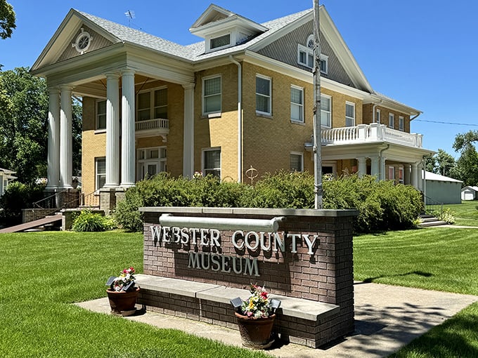 The Webster County Museum stands proudly with its neoclassical columns, a treasure chest of prairie history waiting to be unlocked.