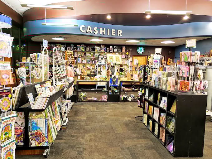 The cashier area serves as command central for this literary universe. Notice the guitars hanging in the background&mdash;books are just the beginning here.