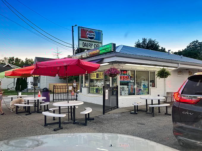 Twilight at Dairy Del transforms this humble ice cream stand into a neighborhood gathering spot. The red umbrellas and outdoor tables invite you to linger and savor summer.