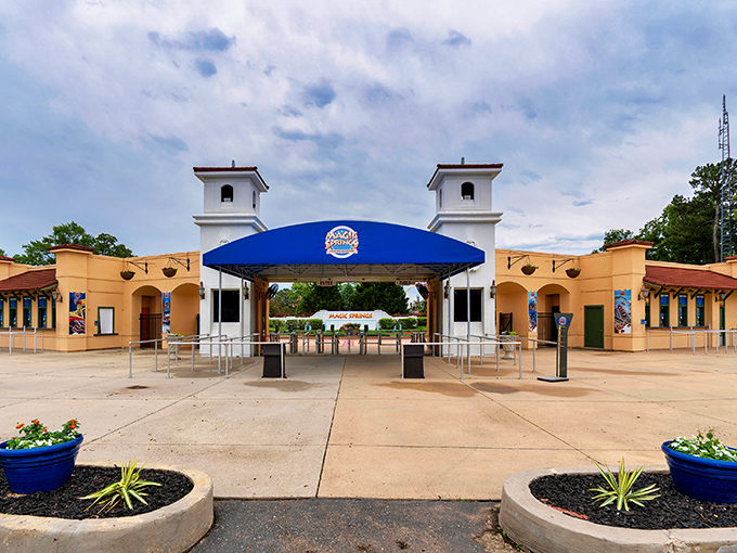 The Spanish-style entrance towers stand like sentinels guarding a realm of pure fun, where adulting is temporarily suspended upon passing through.