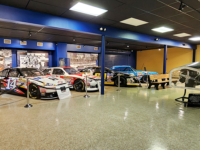 A rainbow of racing royalty lines the showroom floor. These aren't just cars&mdash;they're time machines with sponsor logos and speed stories.