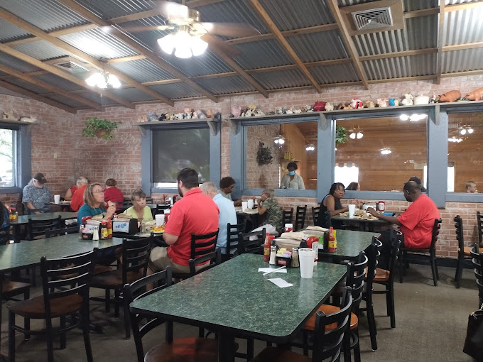 Exposed brick walls and corrugated metal ceilings create that "grandma's country kitchen got an upgrade" vibe that makes you instantly feel at home.