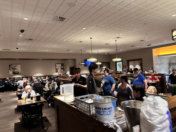 The bustling dining room hums with the universal language of "mmm" as diners strategize their next plate while servers hustle like choreographed dancers.
