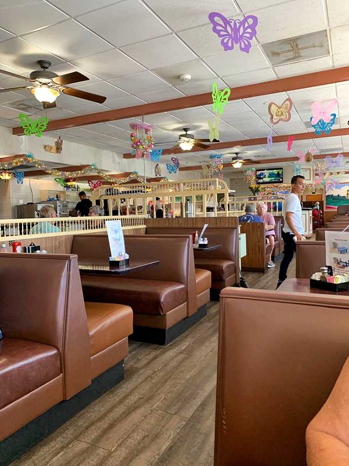 Colorful butterfly decorations flutter above comfortable booths, creating a whimsical diner atmosphere that says "stay awhile" without saying a word.