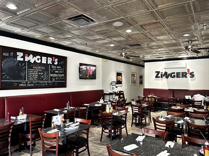 Classic tin ceilings, red booths, and wooden chairs create that perfect deli atmosphere&mdash;not too fancy, not too casual, just authentically right.