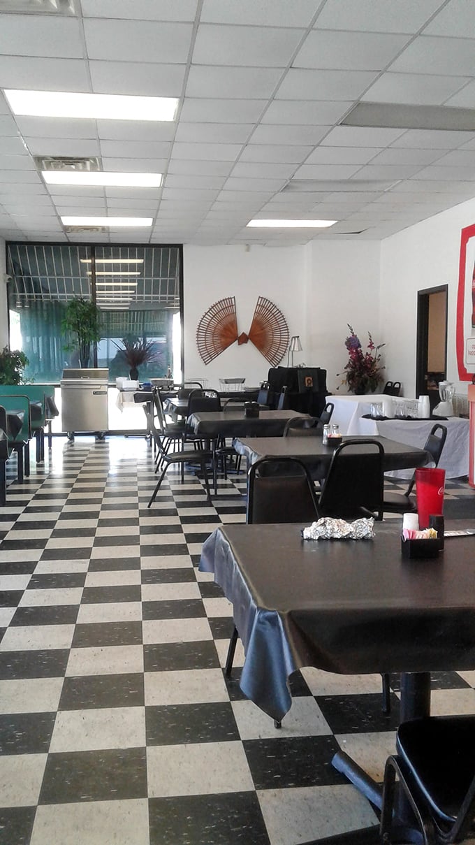 Classic black and white checkered floors set the stage for culinary drama. No fancy frills needed when the food does all the talking.