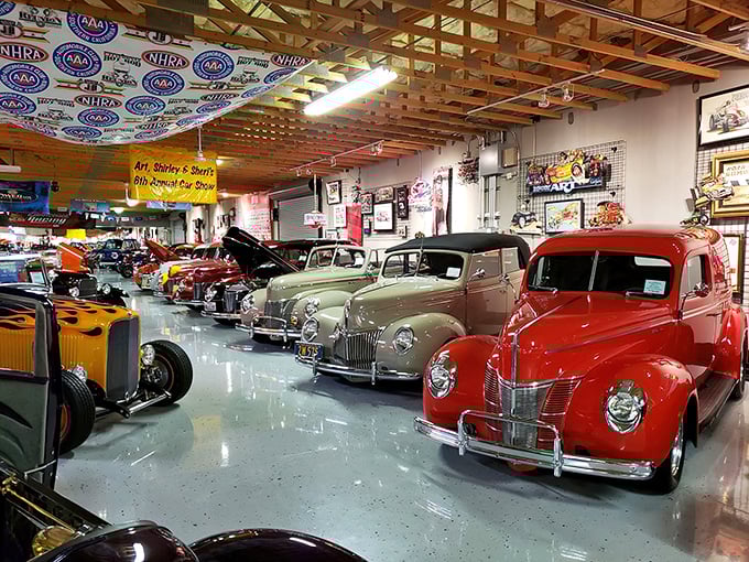Chrome dreams and candy-colored classics line up like soldiers on parade. That polished floor creates a mirror effect that doubles the visual impact.