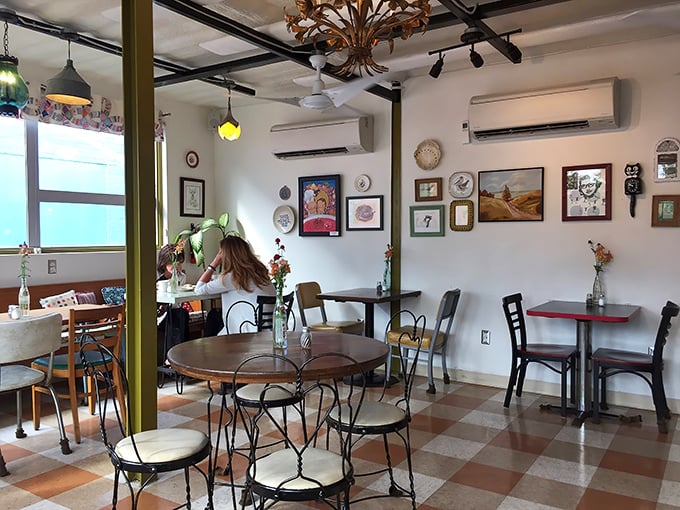 Inside, mismatched furniture and local art create that rare atmosphere where hipsters and grandparents feel equally at home.