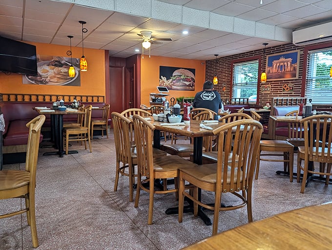 Classic diner ambiance with warm orange walls and wooden furnishings creates that "everybody knows your name" feeling. The exposed brick adds character that chain restaurants spend millions trying to replicate.
