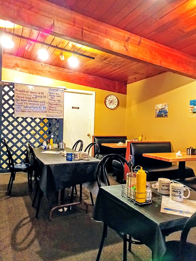 Wooden ceiling beams and lattice dividers create that perfect small-town diner atmosphere where conversations flow as freely as the coffee. Comfort starts before the food even arrives.