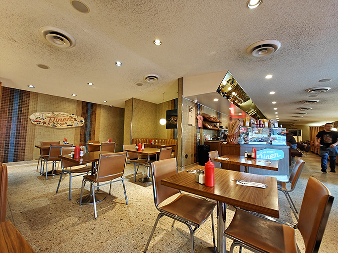 Mid-century modern meets timeless comfort in this wood-paneled sanctuary where every booth feels like the best seat in the house.