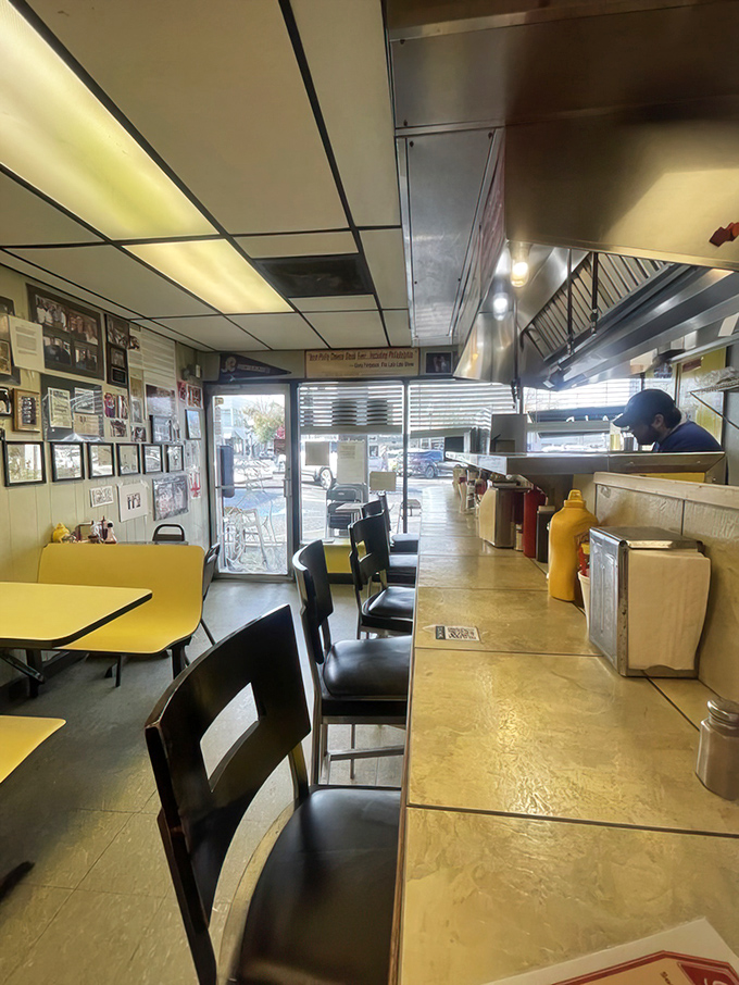 Classic diner perfection: yellow tables, counter seating, and a kitchen where you can watch breakfast magic unfold. This isn't ambiance&mdash;it's authenticity.