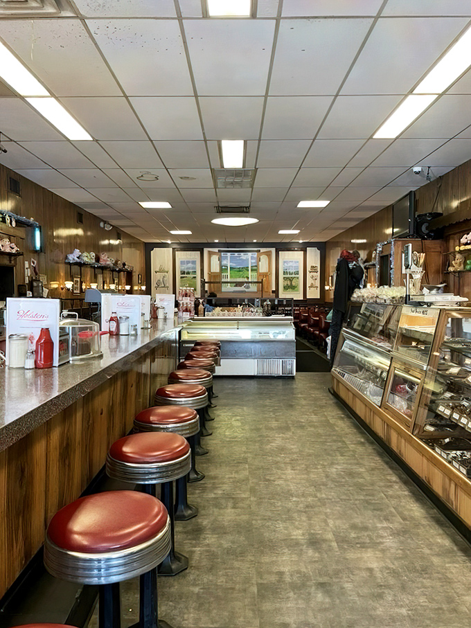Red vinyl stools lined up like loyal soldiers, waiting for the next generation of ice cream enthusiasts to claim their spots.
