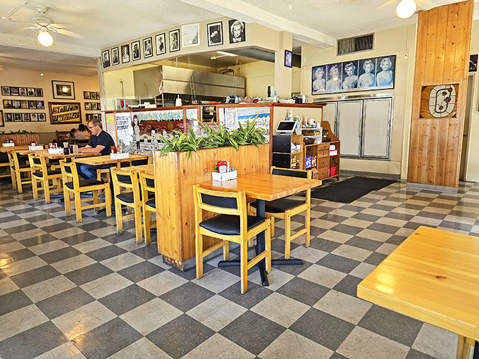 Inside, the checkered floor and photo-lined walls create a time capsule of nostalgia where celebrities smile down as you contemplate a second coffee.