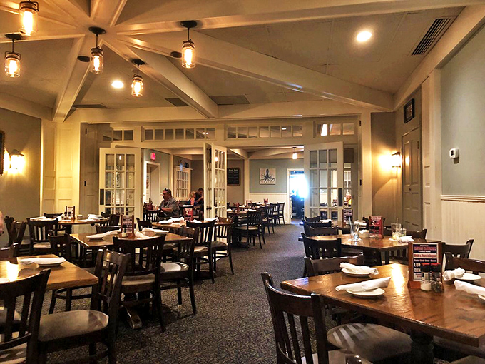 Warm wooden tables bathed in gentle light create the perfect maritime atmosphere for savoring ocean treasures hundreds of miles from any coastline.