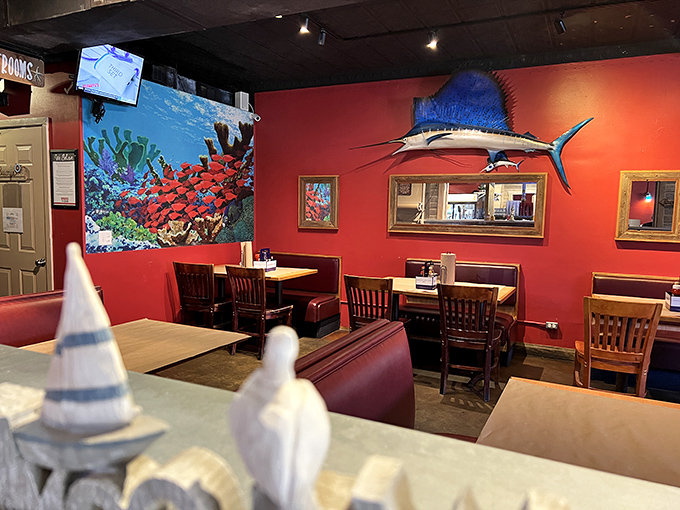 Vibrant red walls and maritime decor create the perfect backdrop for seafood indulgence. That mounted sailfish has witnessed countless "this is the best I've ever had" moments.