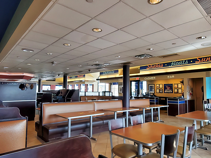 Classic diner seating arranged with mathematical precision &ndash; where conversations hum between tables and refills appear before you realize you need one.