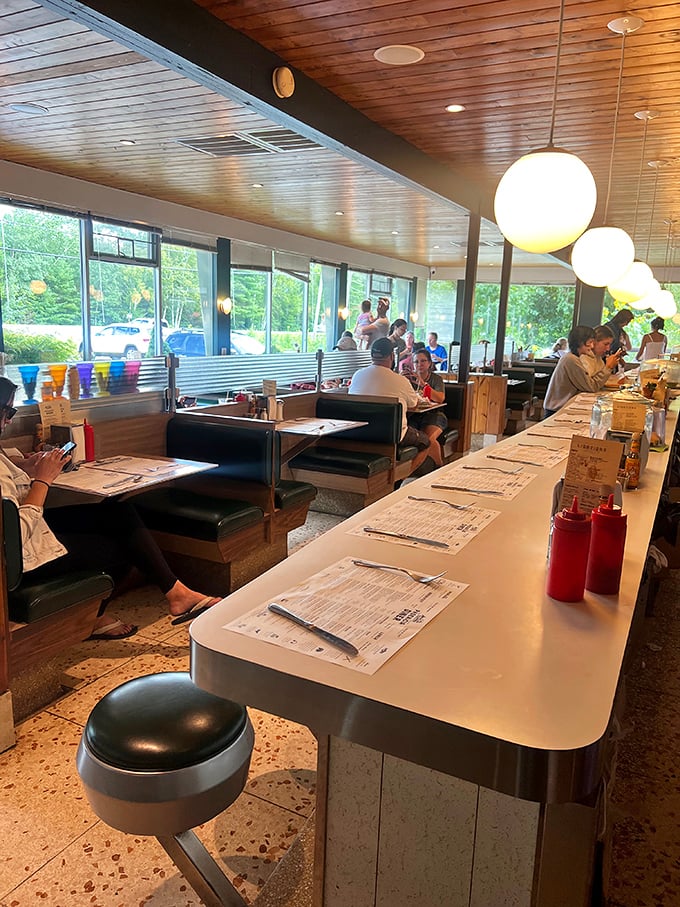 Classic diner counter meets warm wood ceiling. The perfect marriage of nostalgic design and modern comfort where every stool tells a story.
