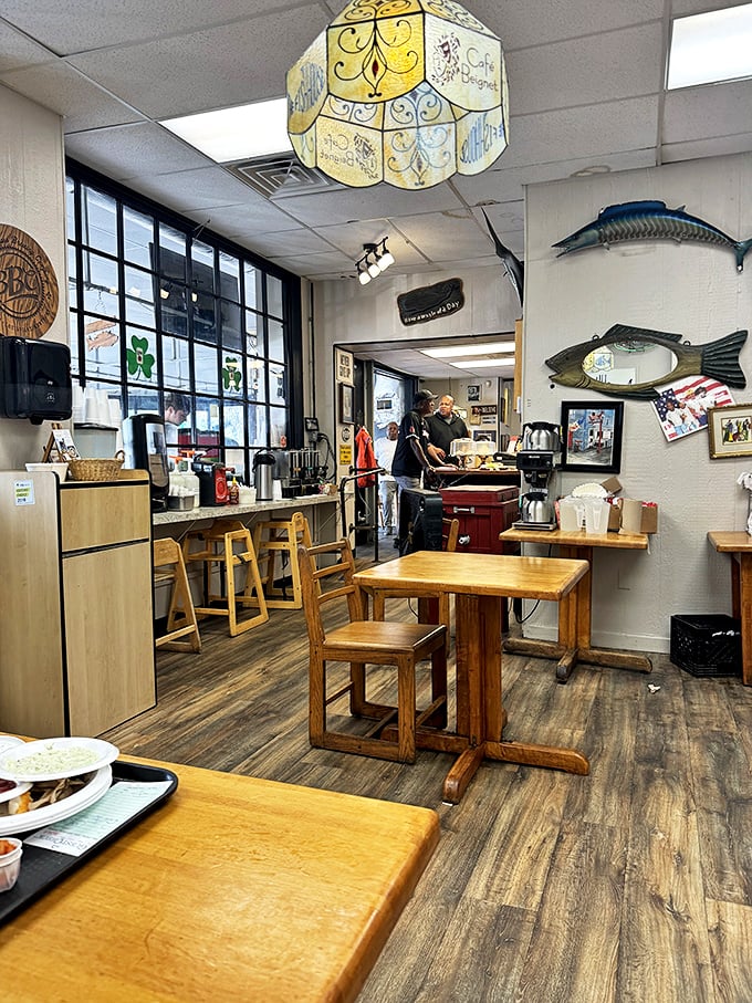 Wooden tables, fish d&eacute;cor, and a vintage lamp create the perfect backdrop for seafood magic. Simplicity with purpose.