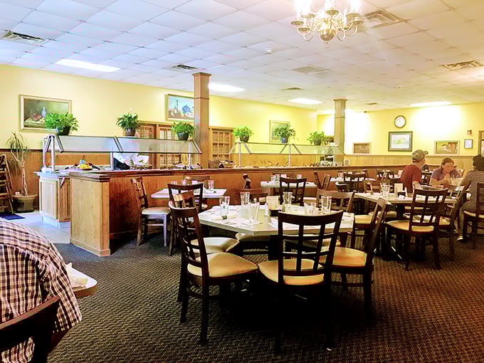Yellow walls and wooden accents create that perfect "welcome home" atmosphere where comfort meets class. The chandeliers aren't showing off&mdash;they're just doing their job.