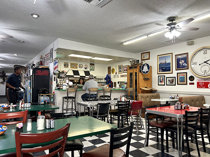 Inside, the classic black-and-white checkered floor and memorabilia-covered walls create that rare atmosphere money can't manufacture&mdash;authentic diner soul.