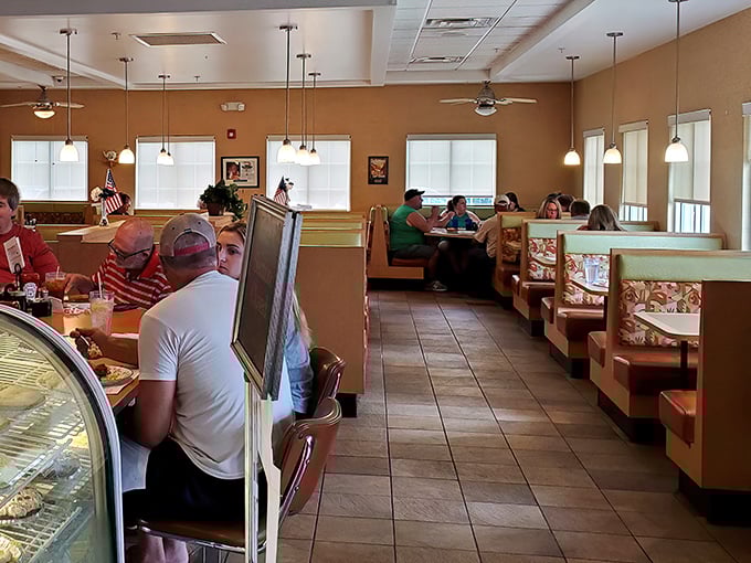 Cozy booths and warm lighting create that perfect diner atmosphere where strangers become neighbors and calories don't count.