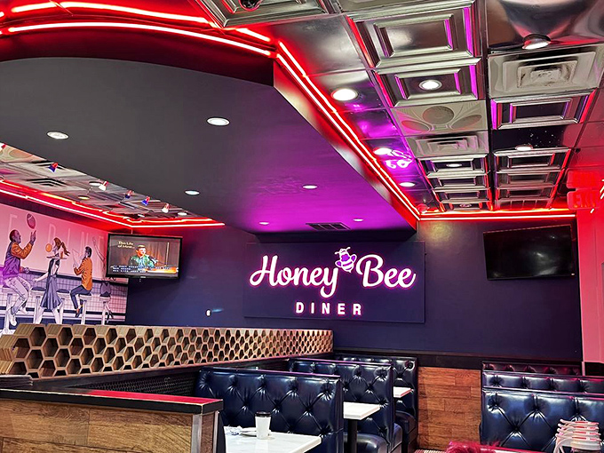 Neon dreams and honeycomb schemes! The interior blends retro diner aesthetics with modern flair, where blue booths invite you to sink in and stay awhile.