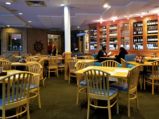 Nautical charm meets dining comfort in this warm interior where ship wheels and wooden accents create the perfect backdrop for seafood feasting.